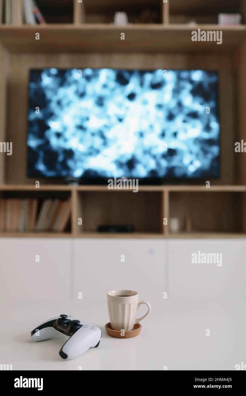 Game controller, joystick on TV screen background. Playing game console ...