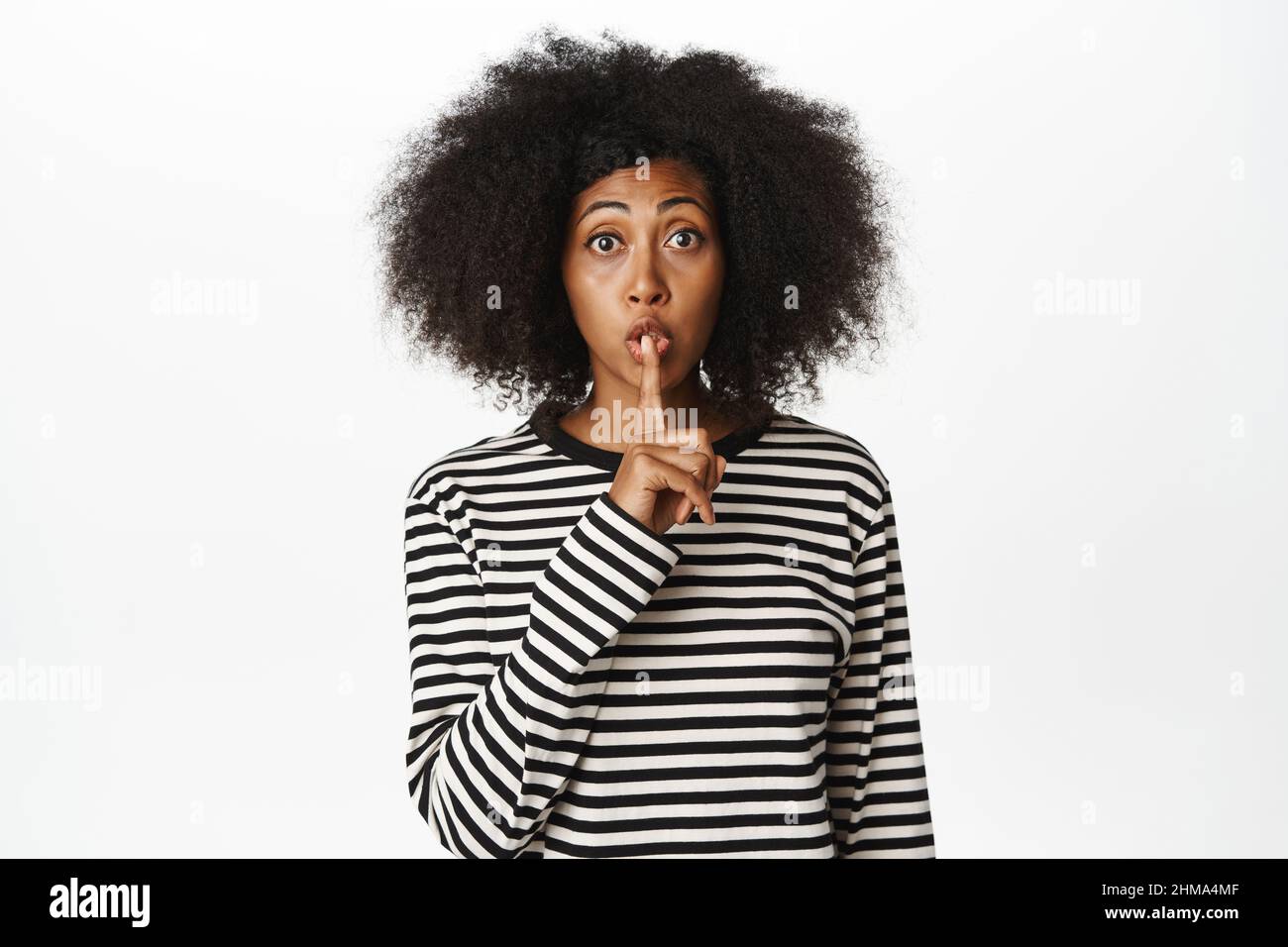 Image of Black female model shows shush, quiet gesture, taboo sign ...