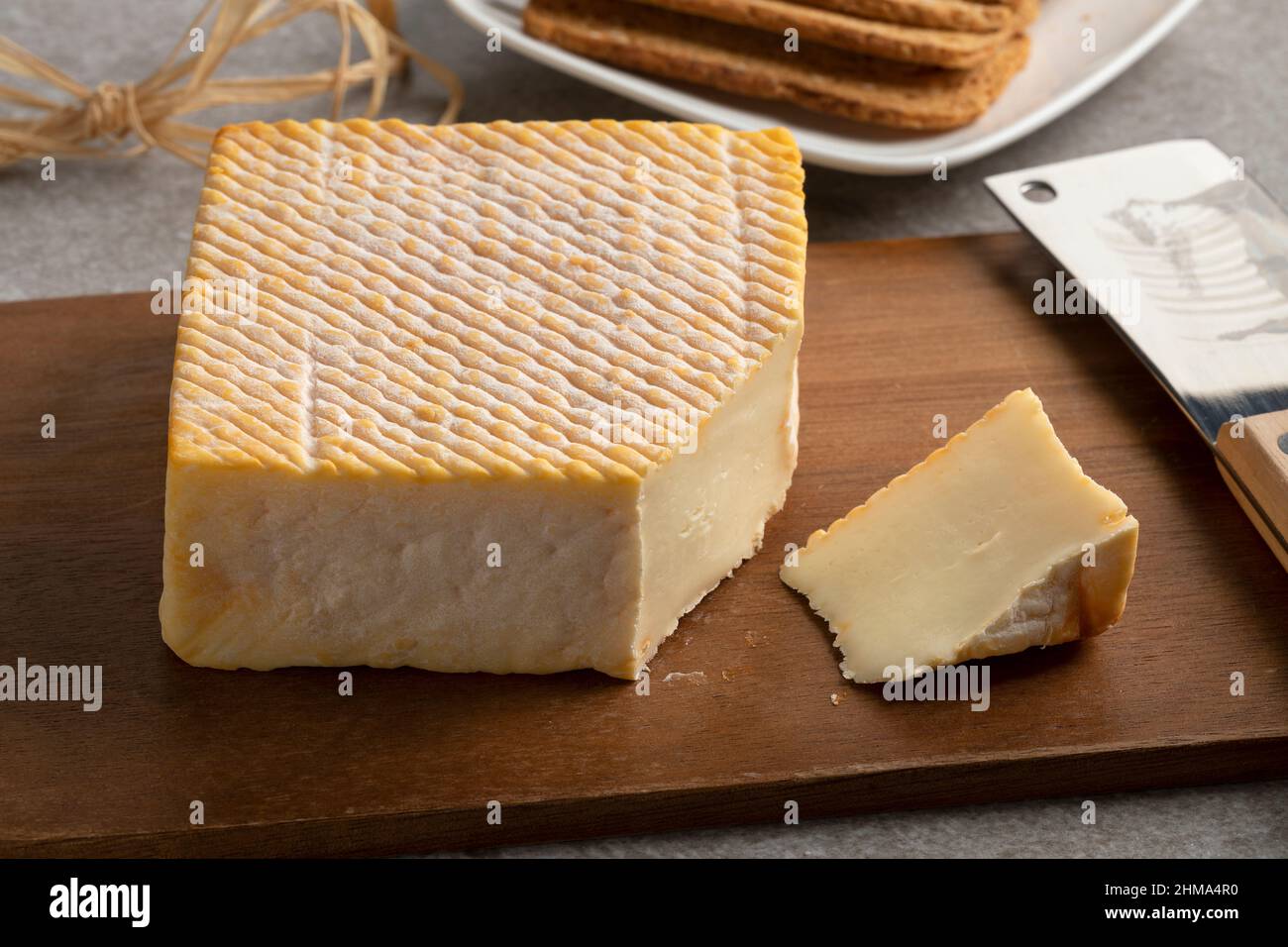 Single French Le Carre du Pere Antoine cheese and a piece close up on a ...
