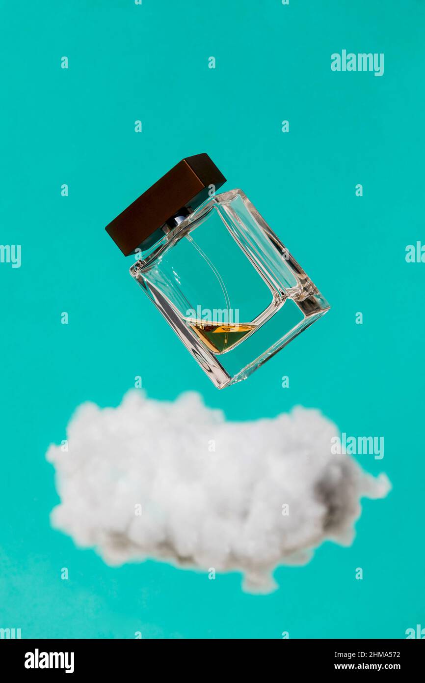 From below of glass bottle of perfume with essence and piece of soft ...