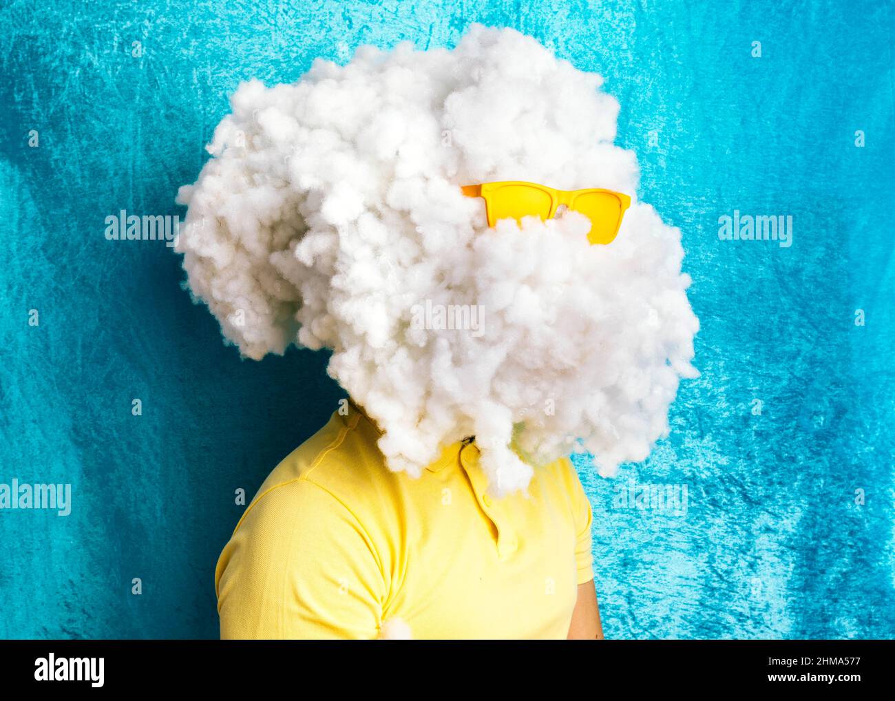 Side view of young unrecognizable thoughtless male with huge soft cloud ...