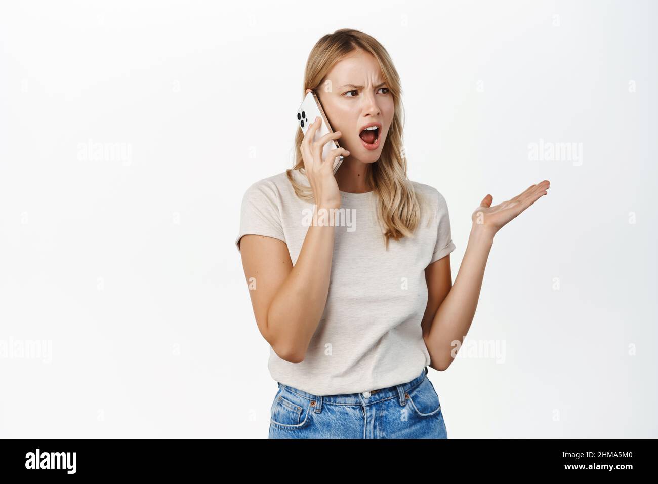 Angry woman talking on mobile phone, arguing over cellphone ...