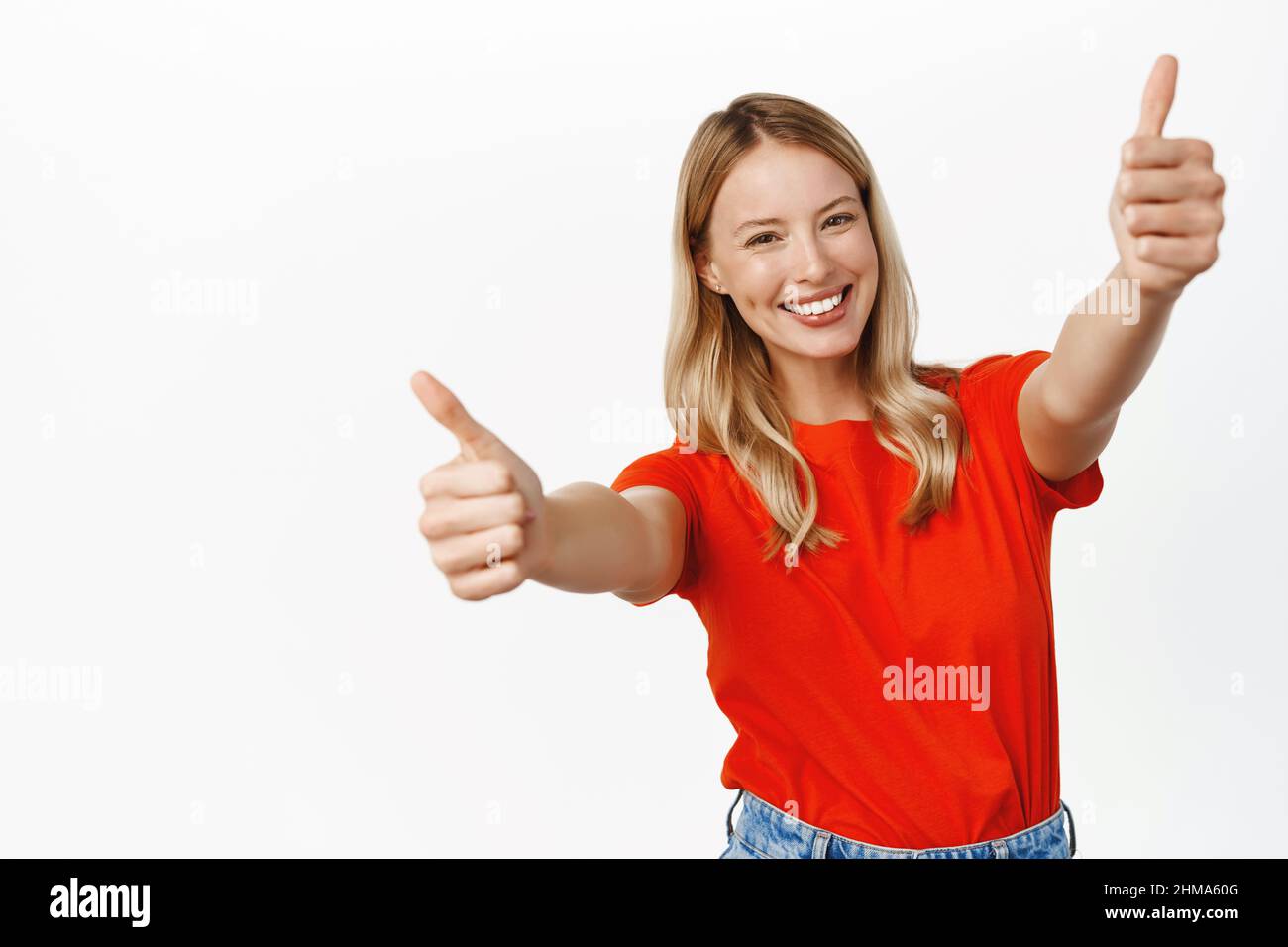 Happy attractive woman smiling, showing thumbs up, approval, like sign ...