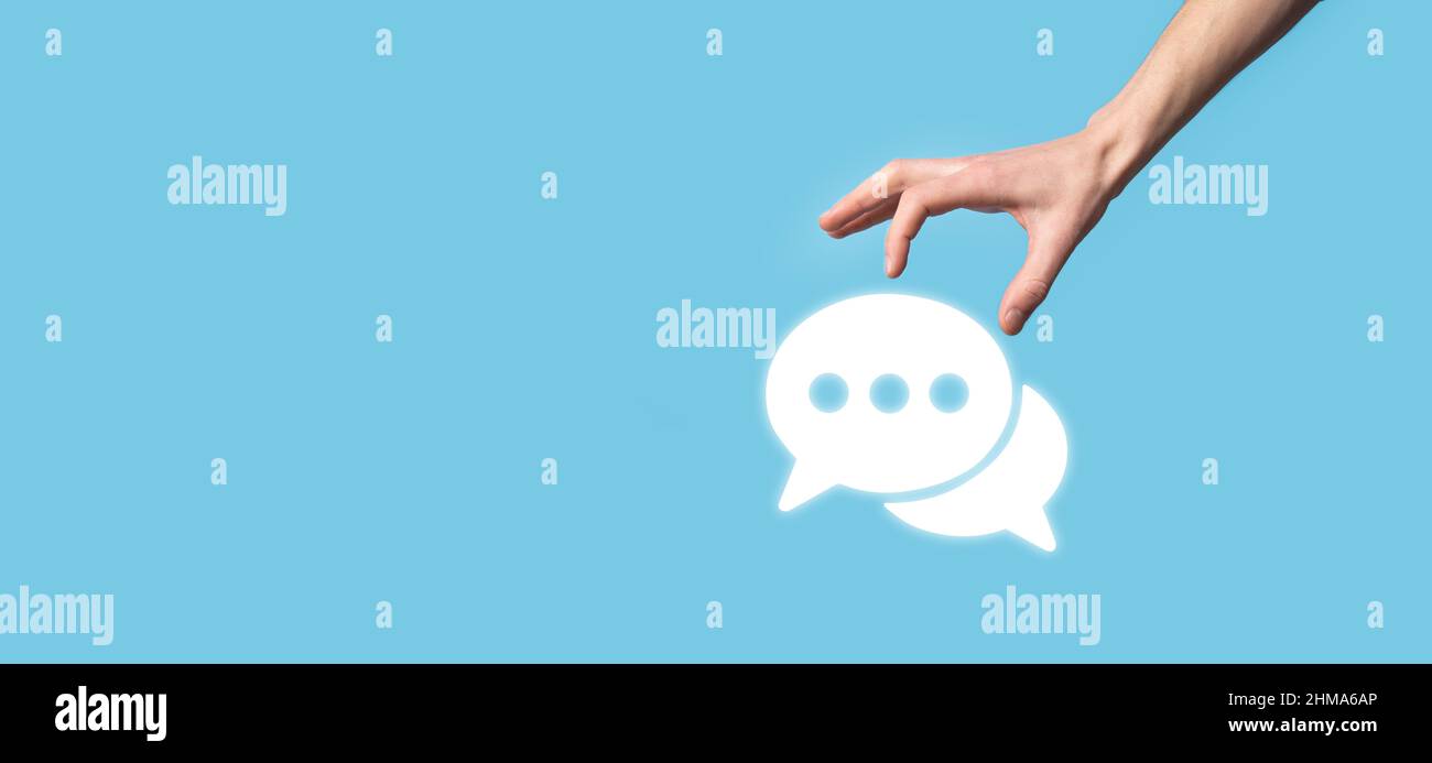 Businessman holding a message icon, bubble talk notification sign in ...