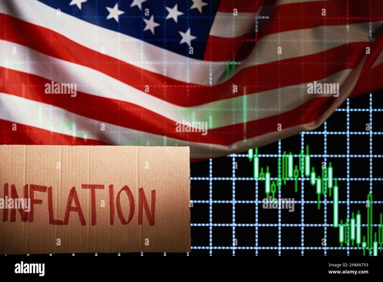 Cardboard with word inflation on background with market exchange rates ...