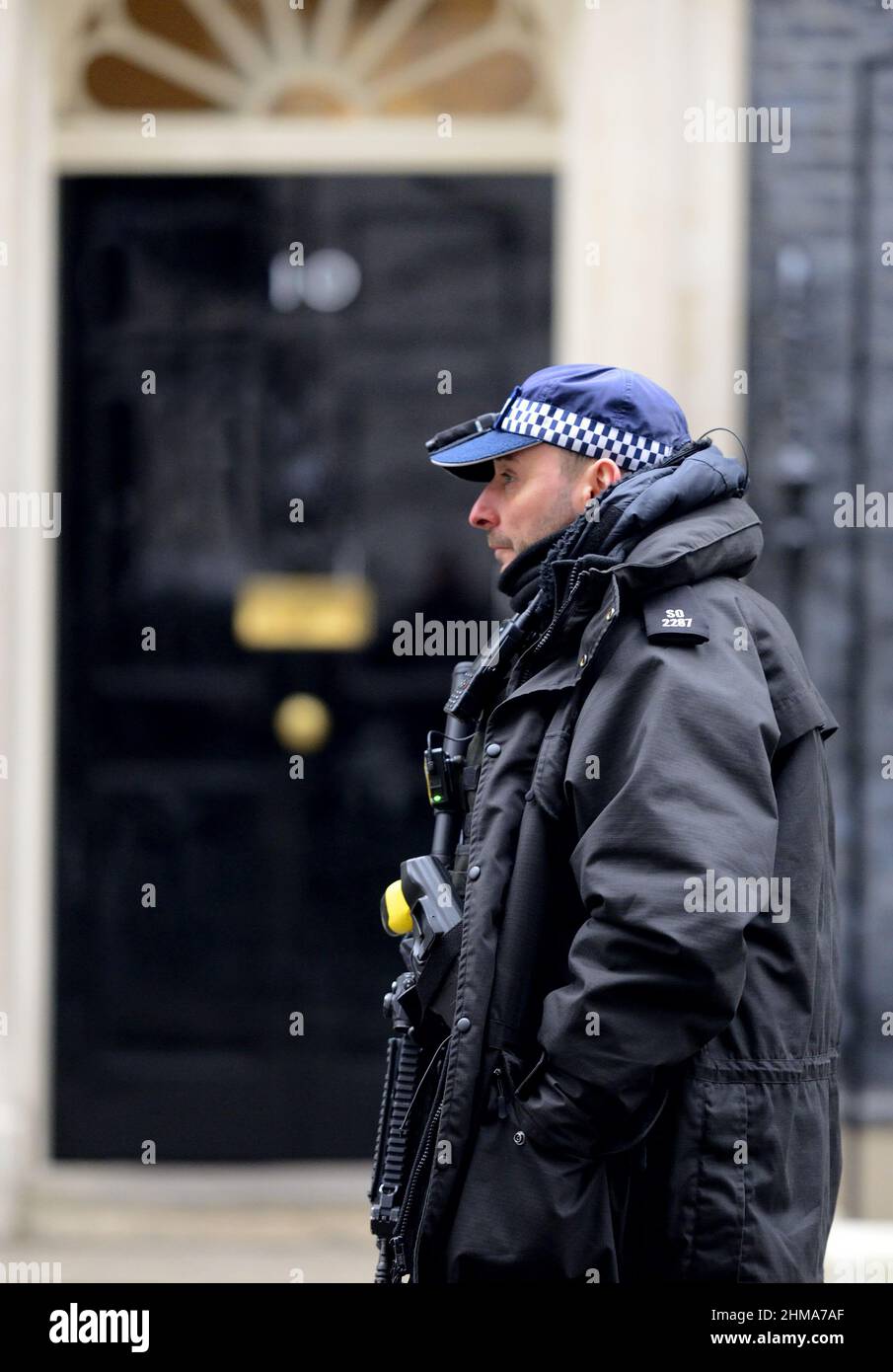 London, England, UK. Police officer passing the door of 10 Downing ...