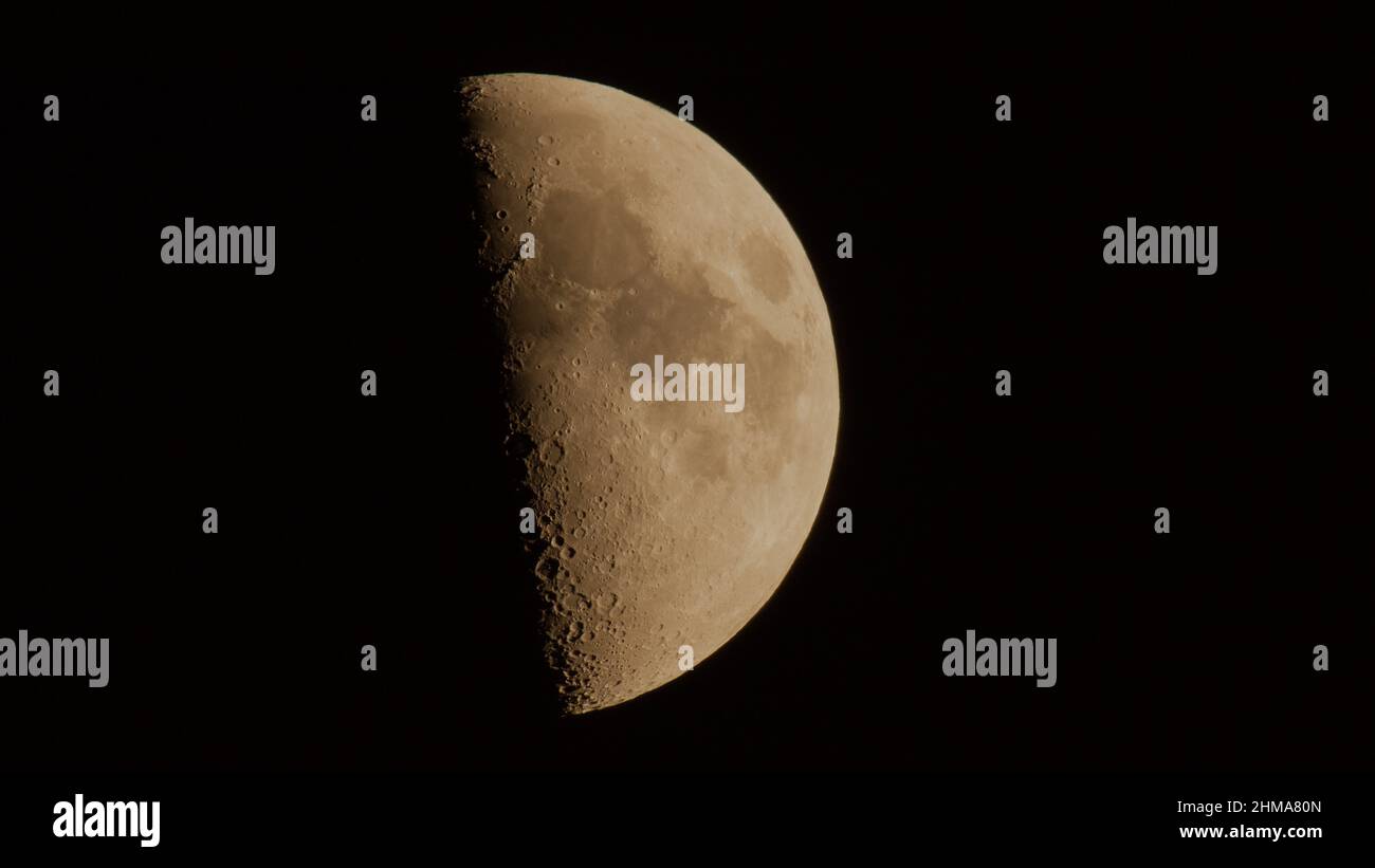 Photograph of Moon in the first quarter lunar phase Stock Photo - Alamy