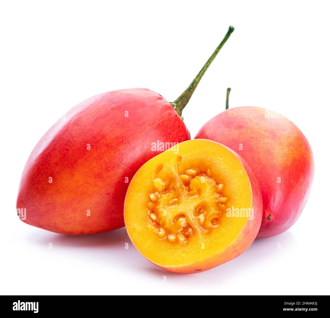 Ripe tamarillo fruits with tamarillo slices isolated on a white ...