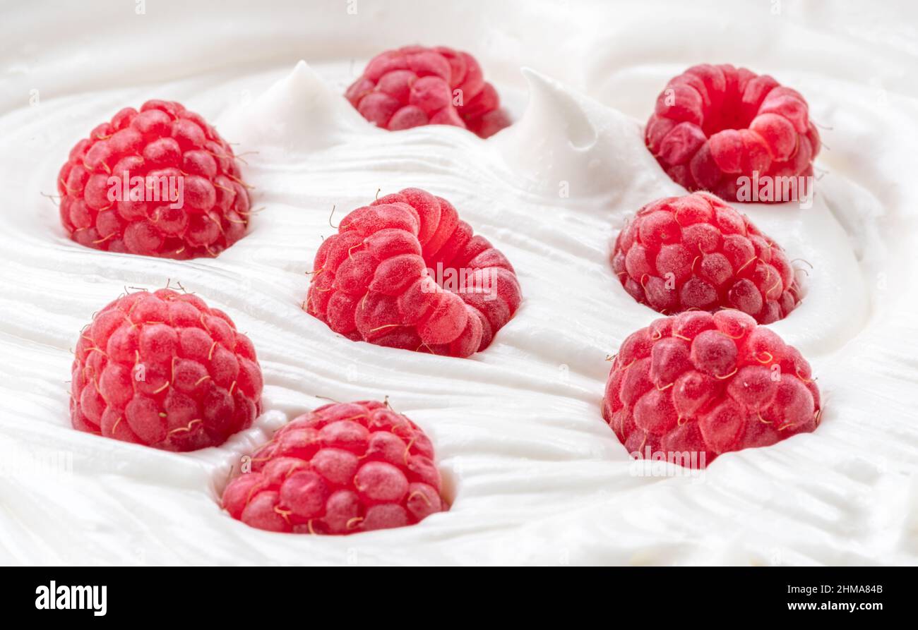 Fresh raspberries in the yoghurt or cream. Top view Stock Photo - Alamy
