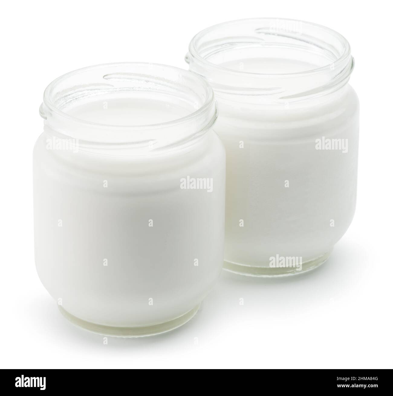 Two glass containers with plain yoghurt isolated on white background ...