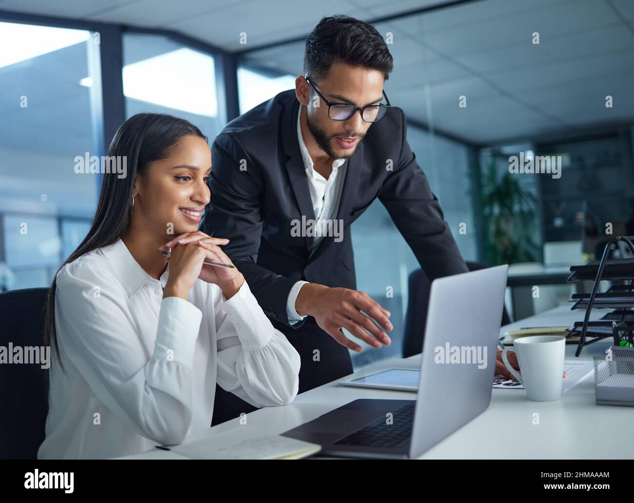 Together well solve this. Shot of two work colleagues working together ...