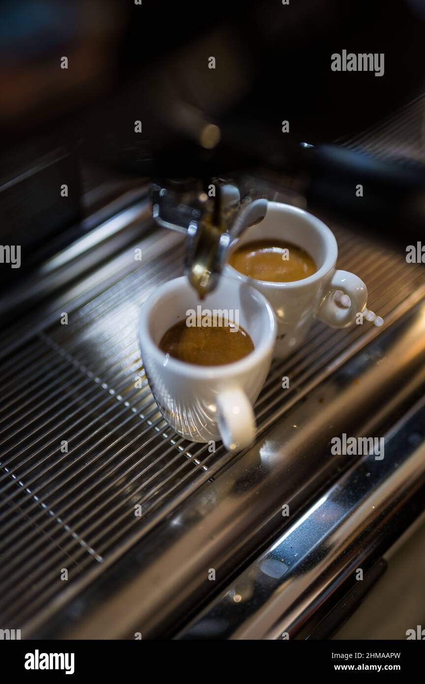 Vertical shot of espresso preparation in coffee machine Stock Photo - Alamy
