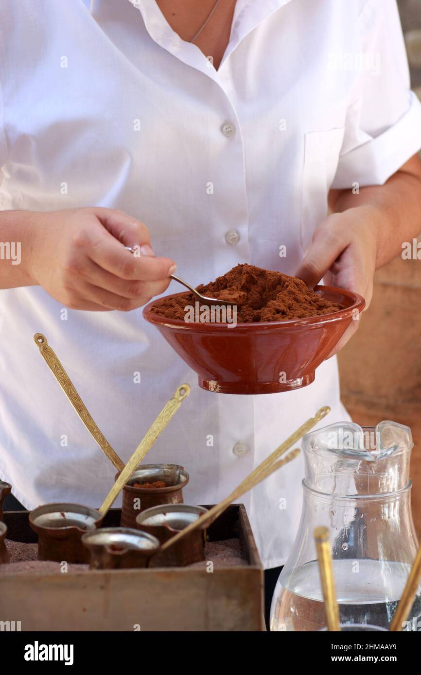 Woman takes ground coffee for preparation at the restaurant Stock Photo ...