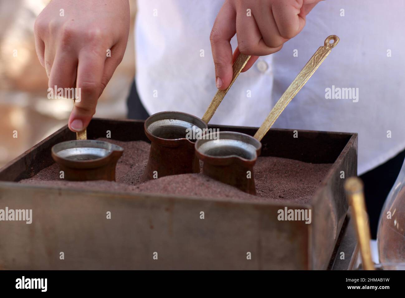 The installation of coffee pots in the sand Stock Photo - Alamy