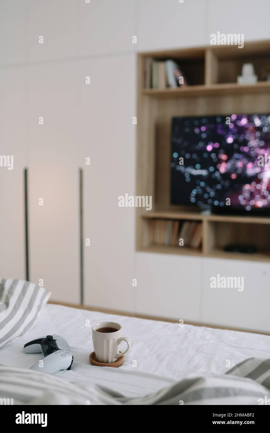 Game controller, joystick on TV screen background. Playing game console ...