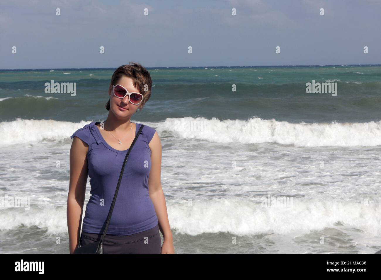 The tourist poses on Mediterranean sea background, Crete Stock Photo ...