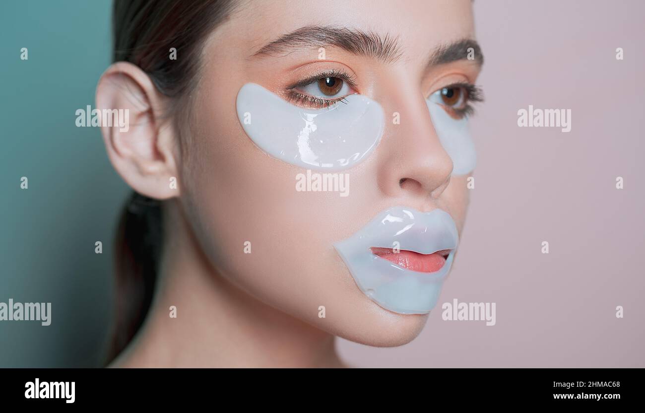 Healthy beautiful girl with natural makeup applies collagen catches for ...