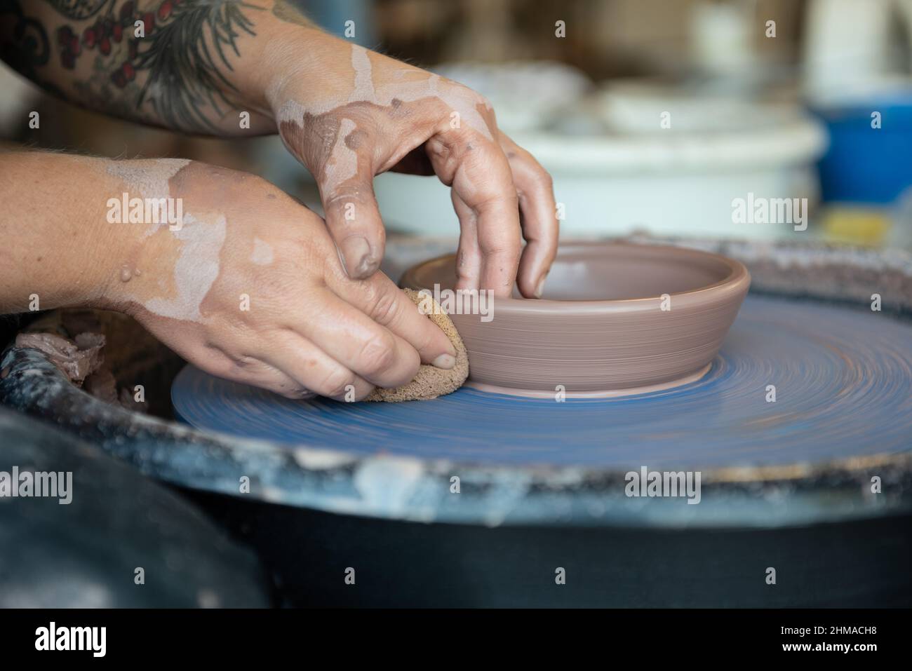 Hands forming a piece of clay on a pottery wheel Stock Photo - Alamy