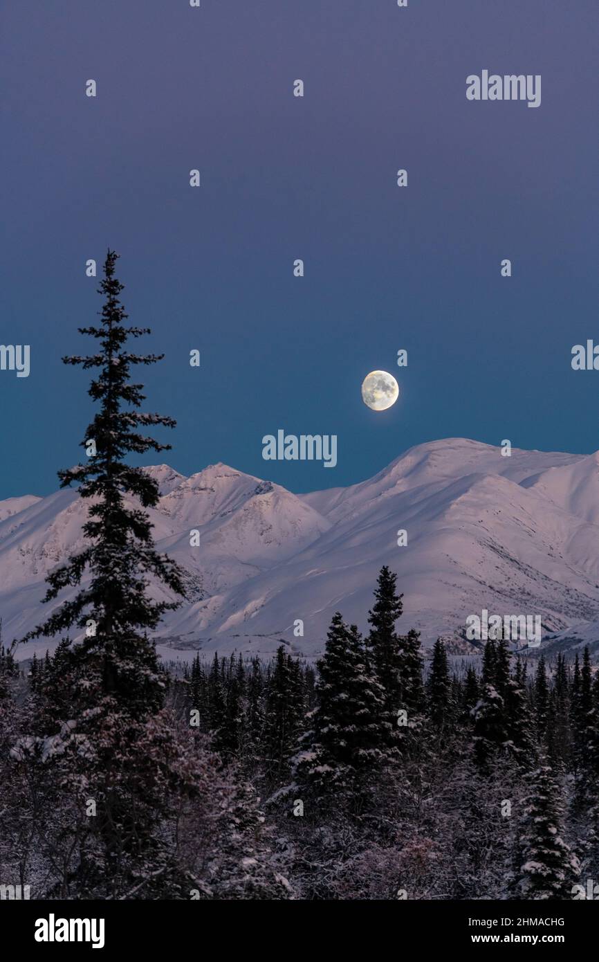 Full moon above the mountains in Alaska Stock Photo - Alamy