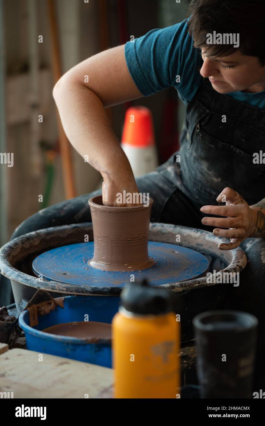 Hands forming a piece of clay on a pottery wheel Stock Photo - Alamy