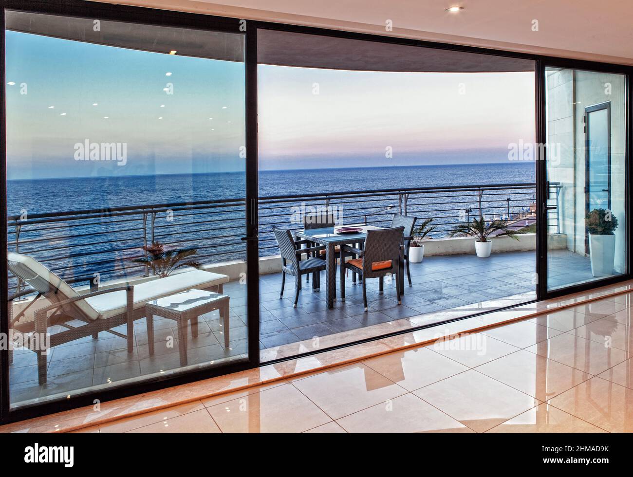 Modern Seafront Balcony with Table and Chairs Stock Photo - Alamy