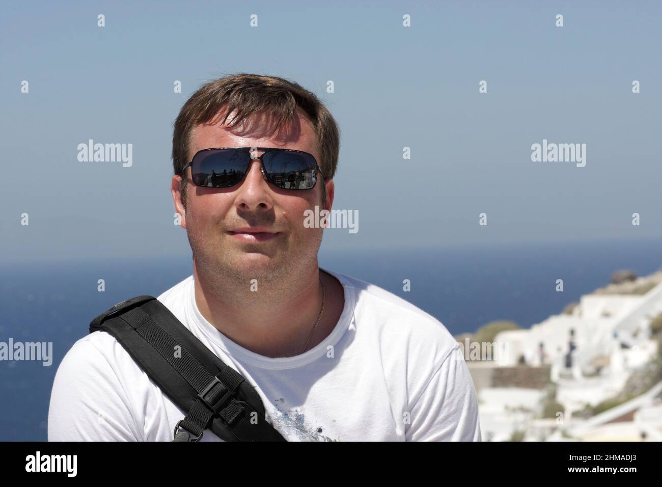 The man poses on the sea background, Santorini, Greece Stock Photo - Alamy