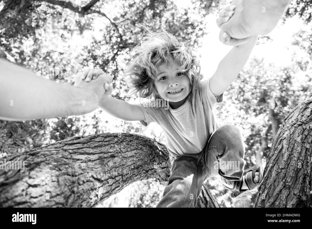 Father helping son to climb tree hi-res stock photography and images ...