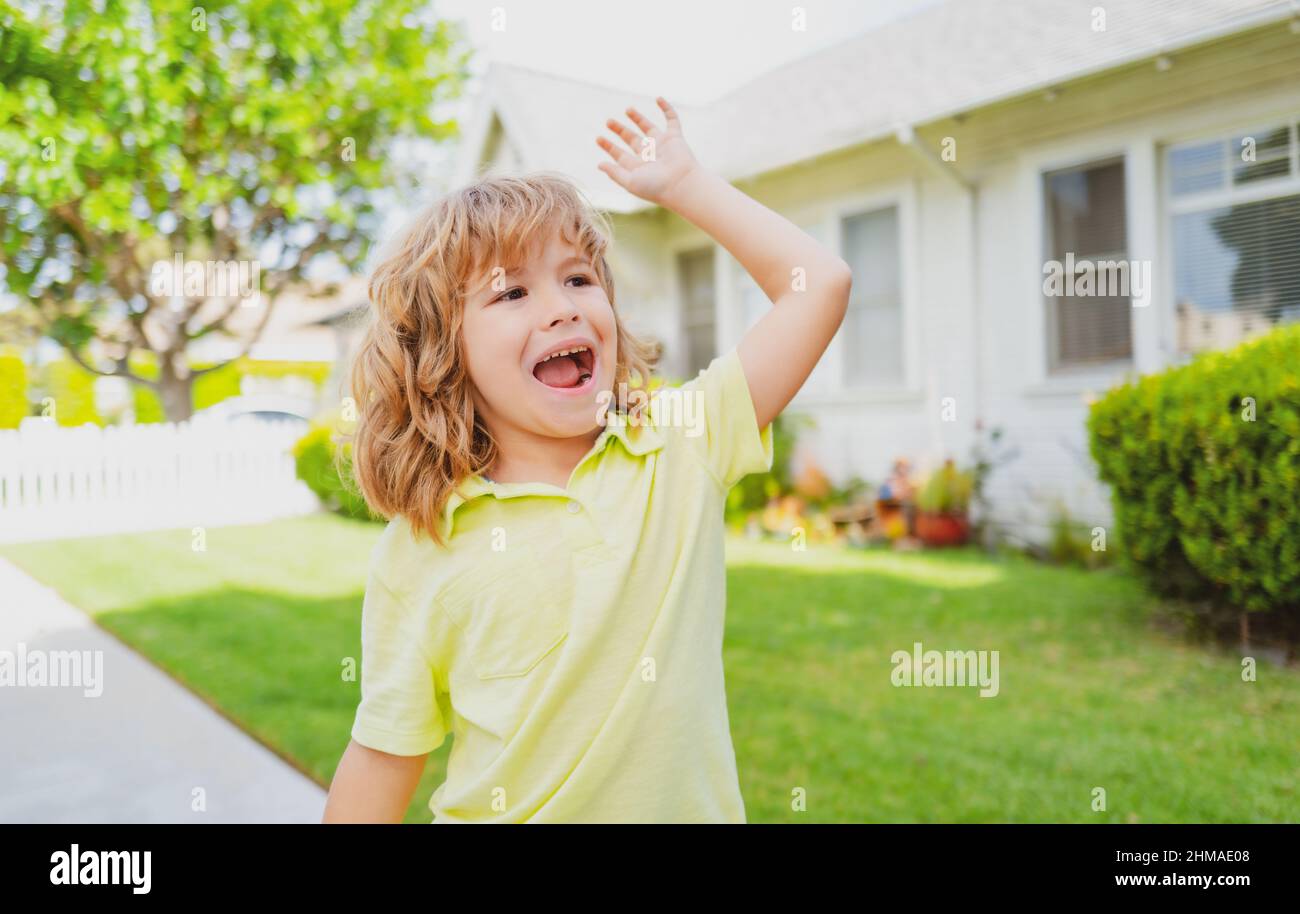 Boy with good bye or hello sign outdoor. Kids with funny face bye bye ...