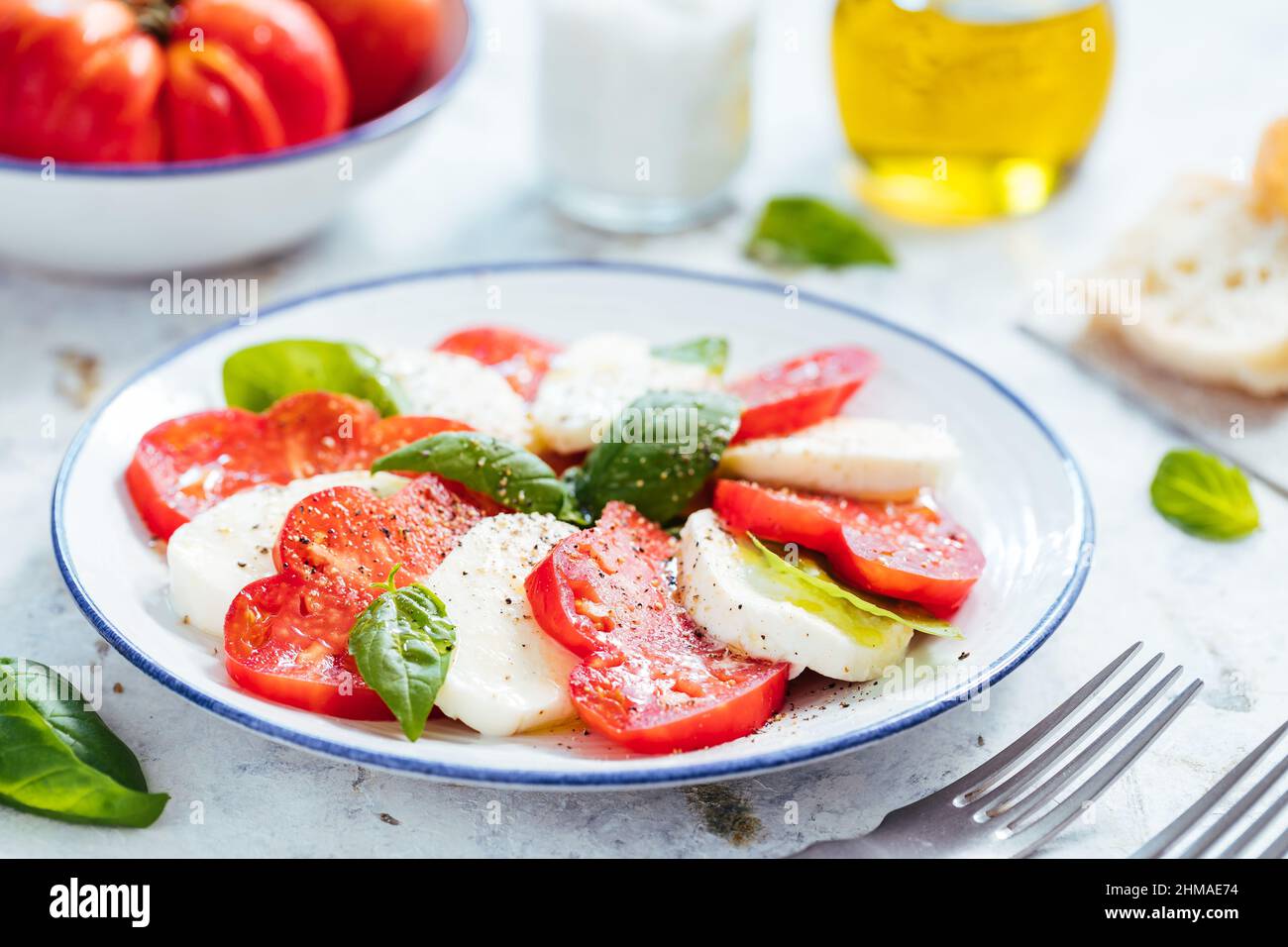 Fresh Caprese salad with mozzarella, tomato and fresh basil with olive ...