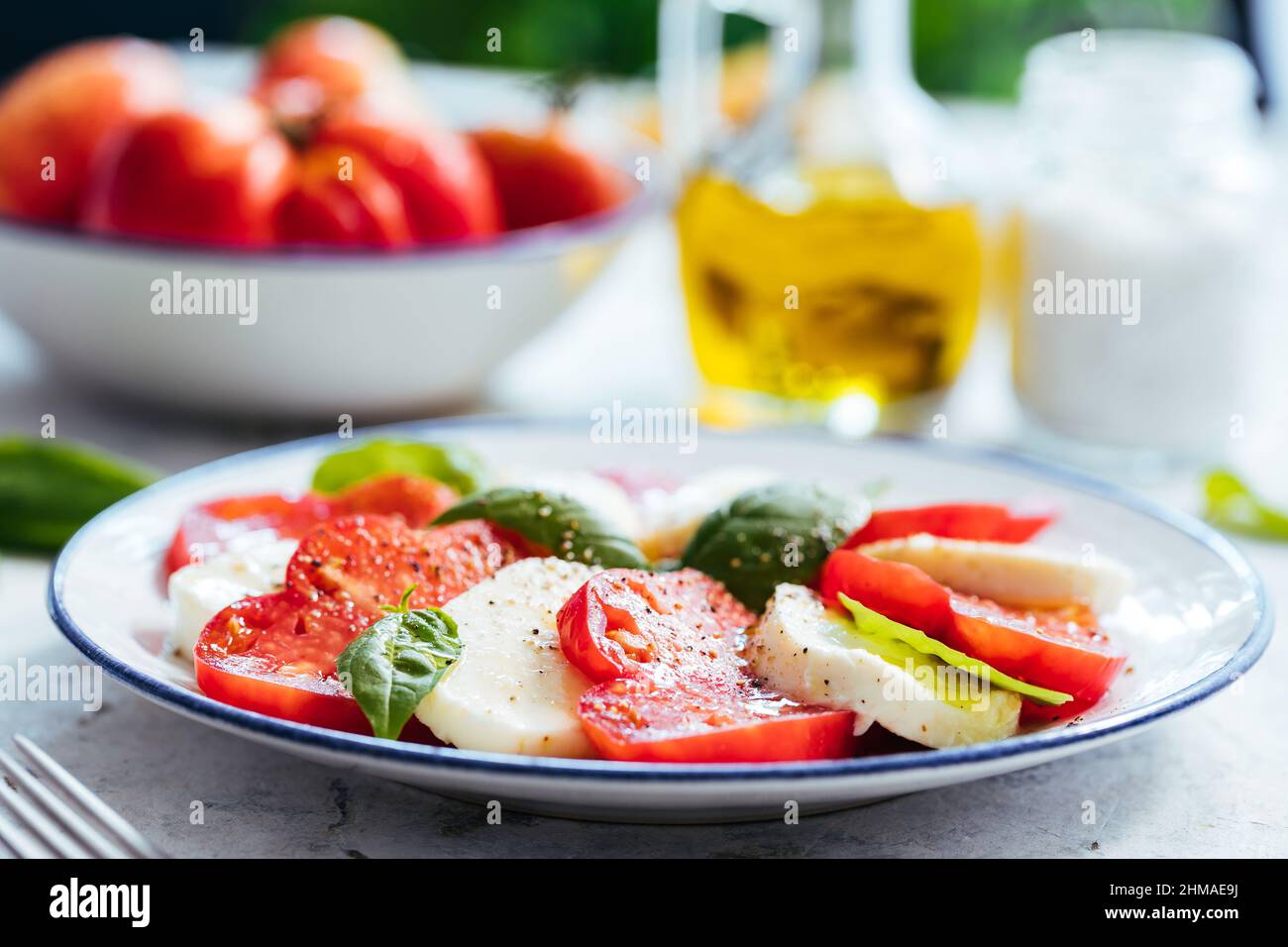 Fresh Caprese salad with mozzarella, tomato and fresh basil with olive ...