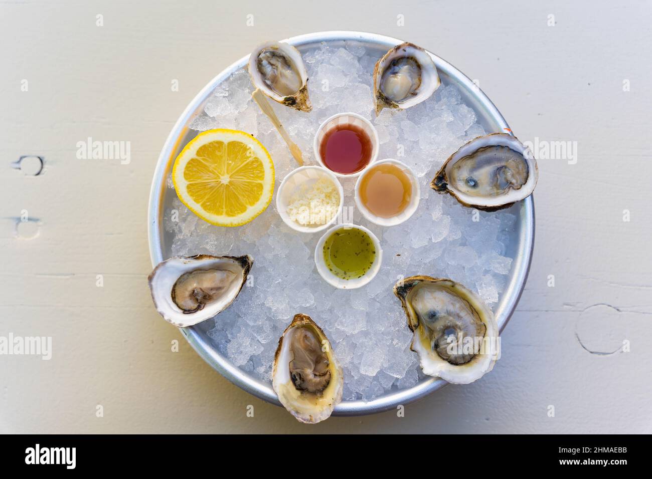 Raw oysters prepared on the half shell over ice Stock Photo - Alamy