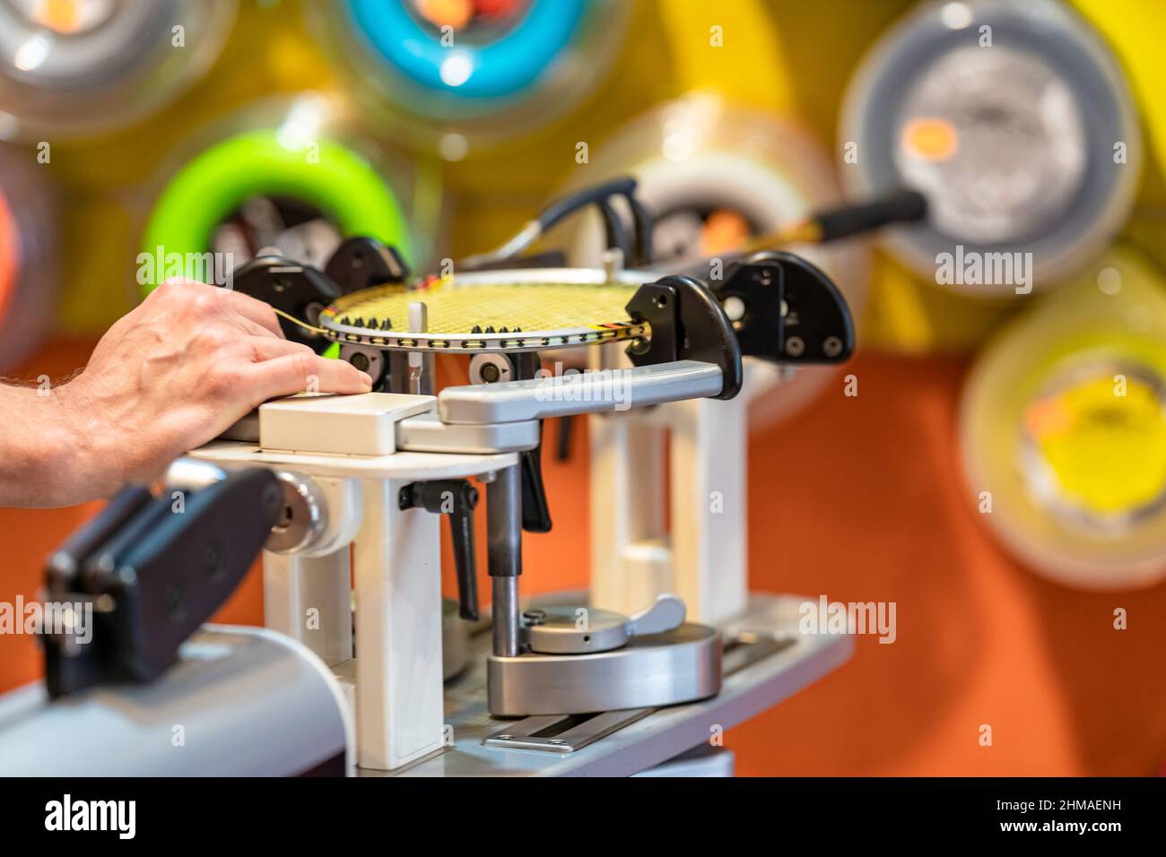 manual stringing of a badminton racket in service Stock Photo - Alamy