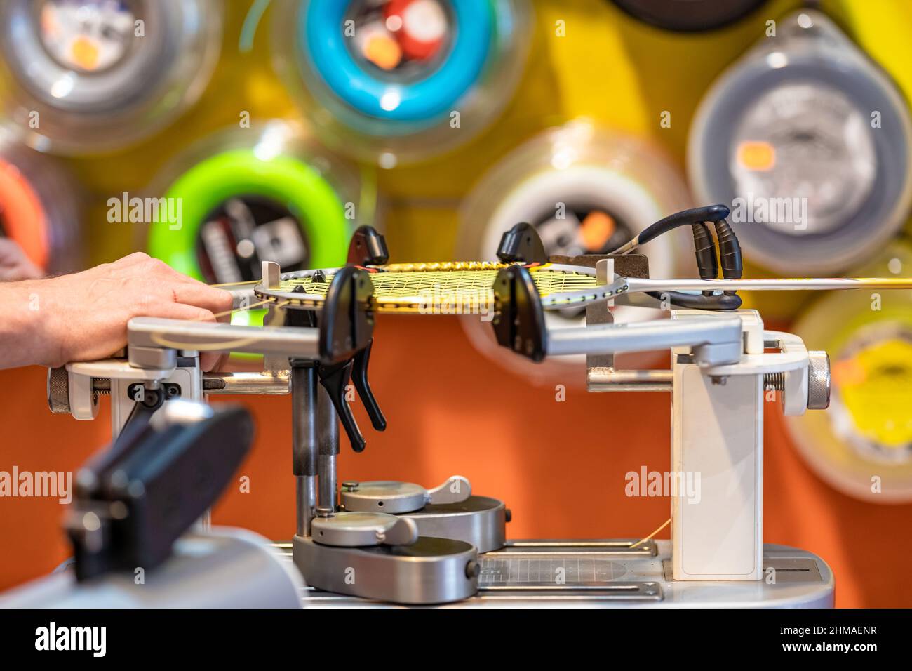 manual stringing of a badminton racket in service Stock Photo - Alamy
