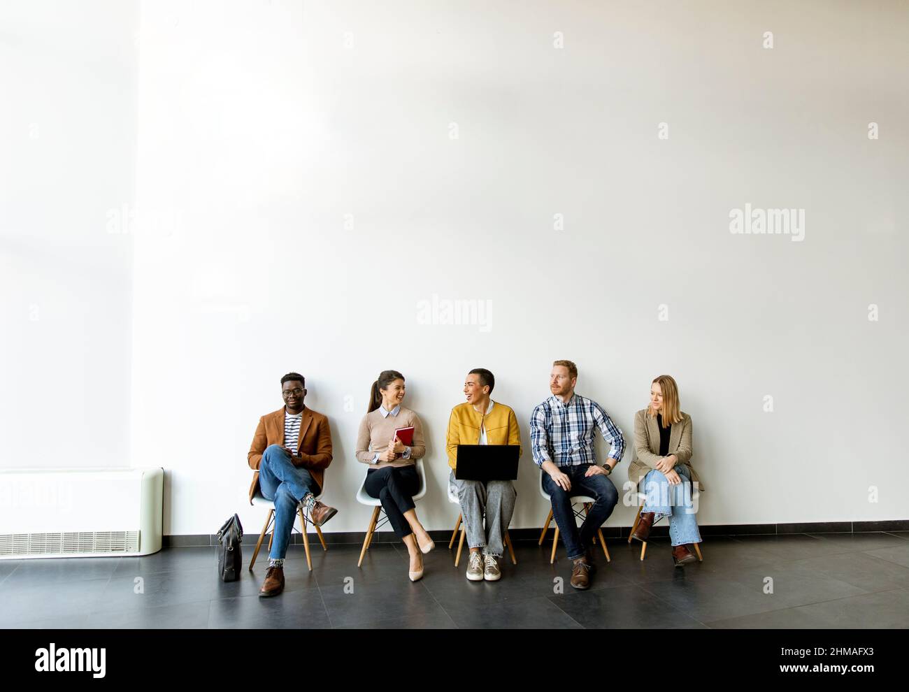Group of bored young people waiting for the job interview Stock Photo ...