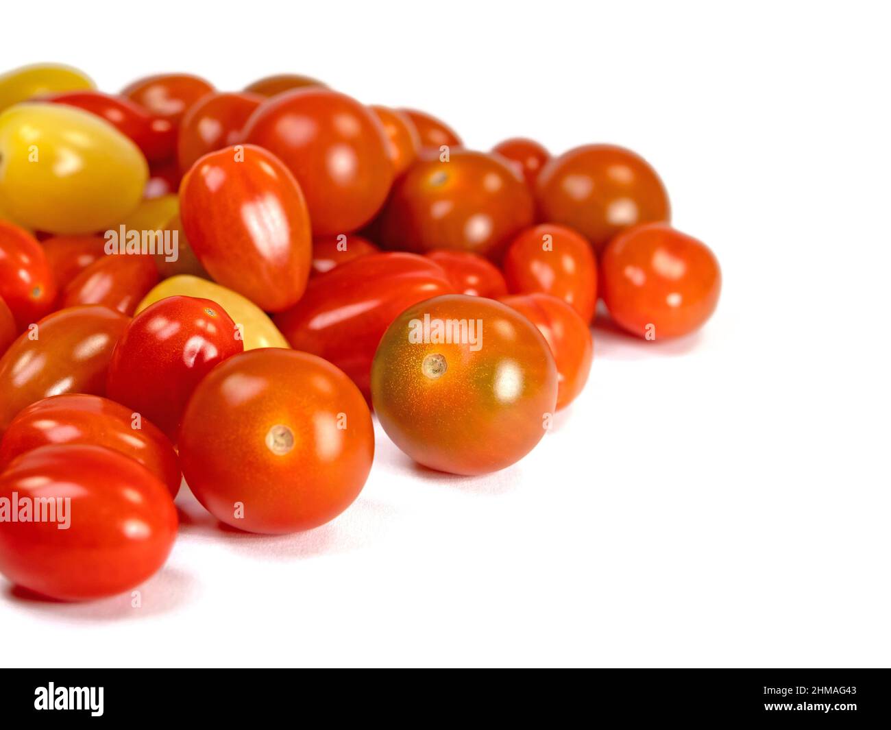Various mini tomatoes against a white background Stock Photo - Alamy
