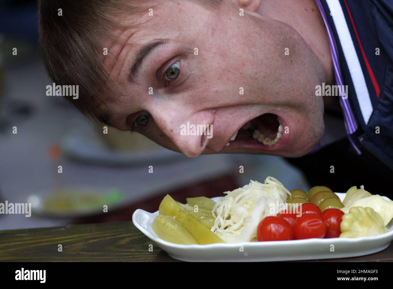 Very hungry man eats a pickled vegetables Stock Photo - Alamy