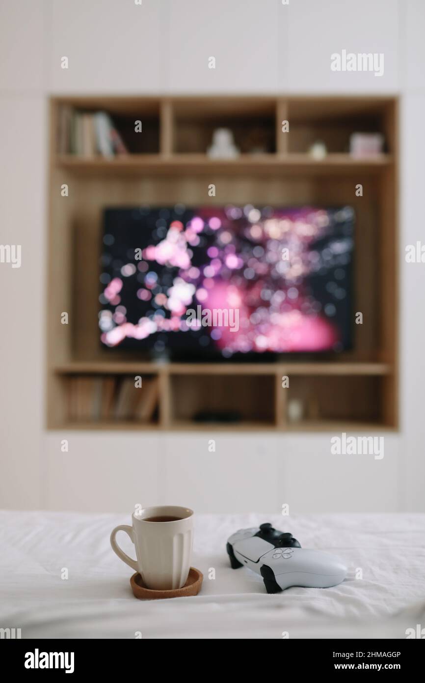 Game controller, joystick on TV screen background. Playing game console ...