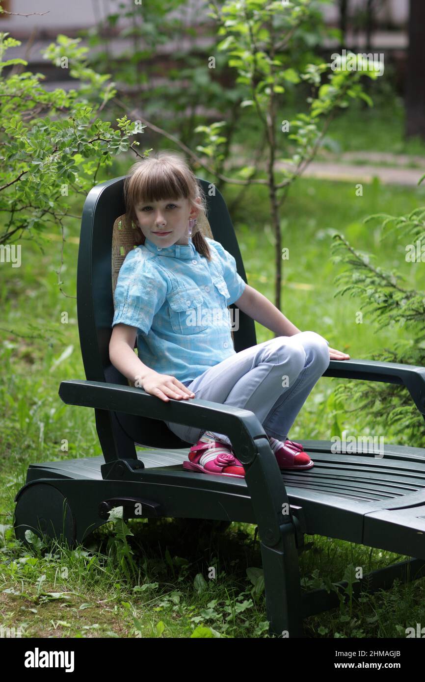 The girl poses on deck chair, outdoor Stock Photo - Alamy