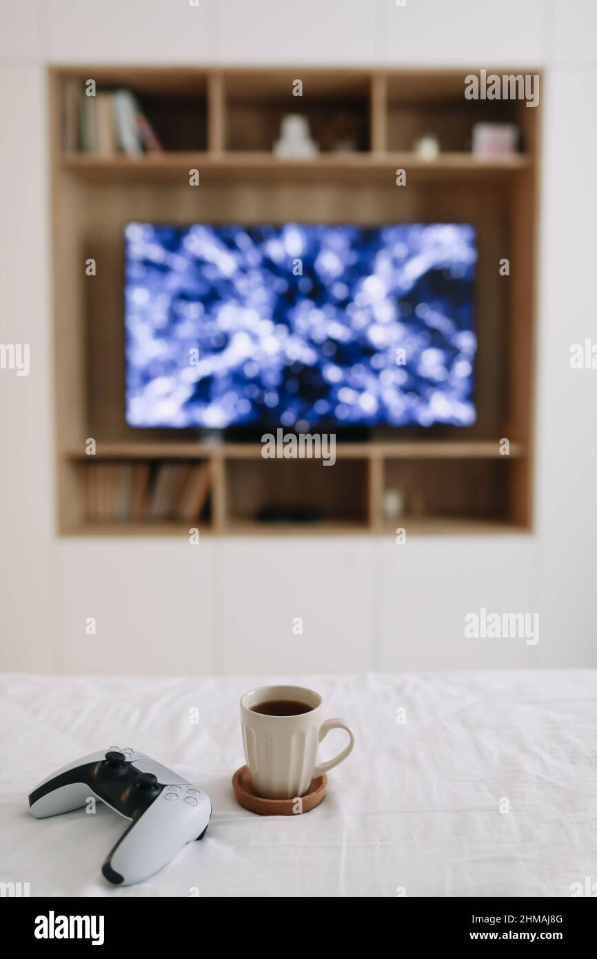 Game controller, joystick on TV screen background. Playing game console ...