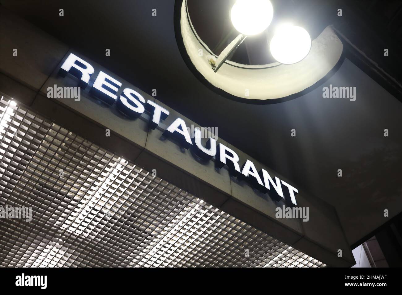 View of glowing restaurant sign board at night Stock Photo - Alamy
