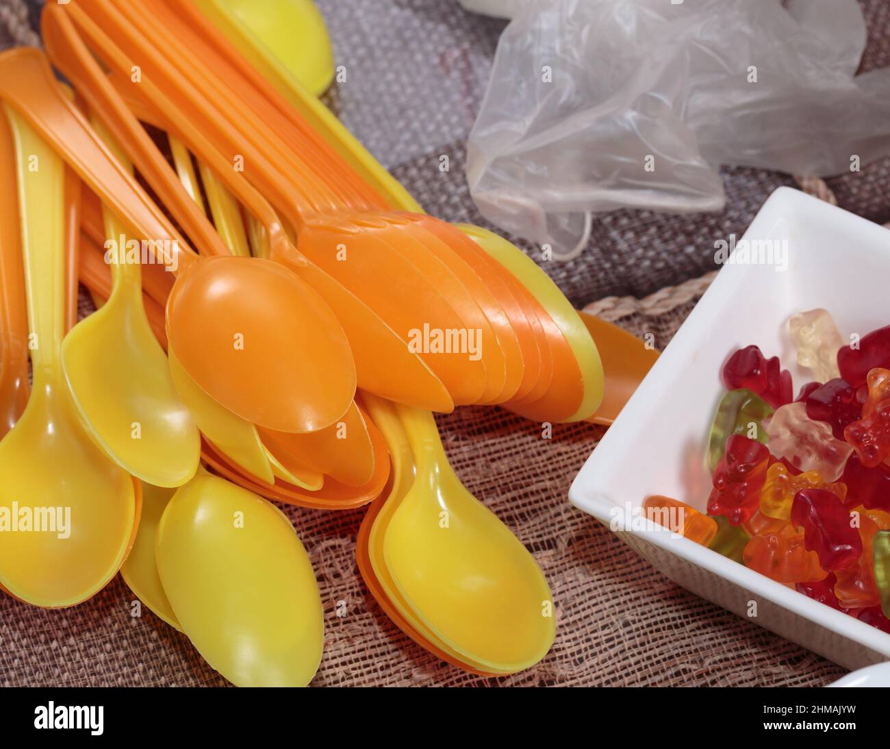 Colorful plastic spoons and gummy bears. Close-up Stock Photo - Alamy