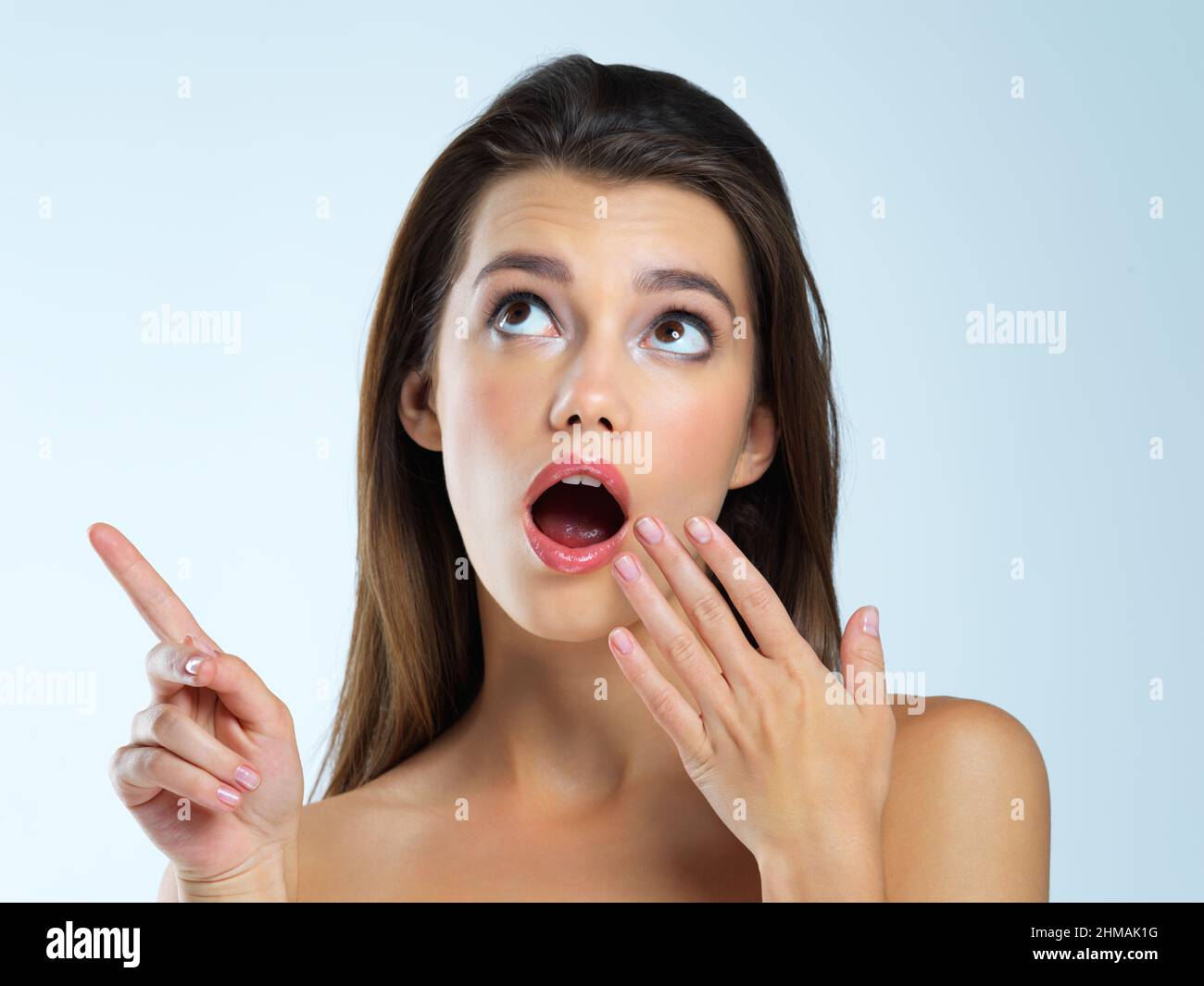 Surprised by modern beauty techniques. Studio shot of a beautiful young ...