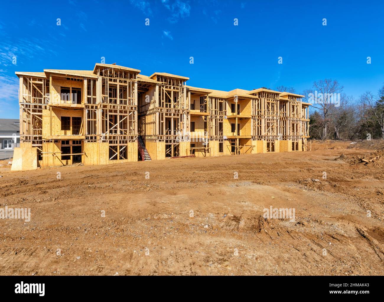 Horizontal shot of a new multi-family apartment building under ...