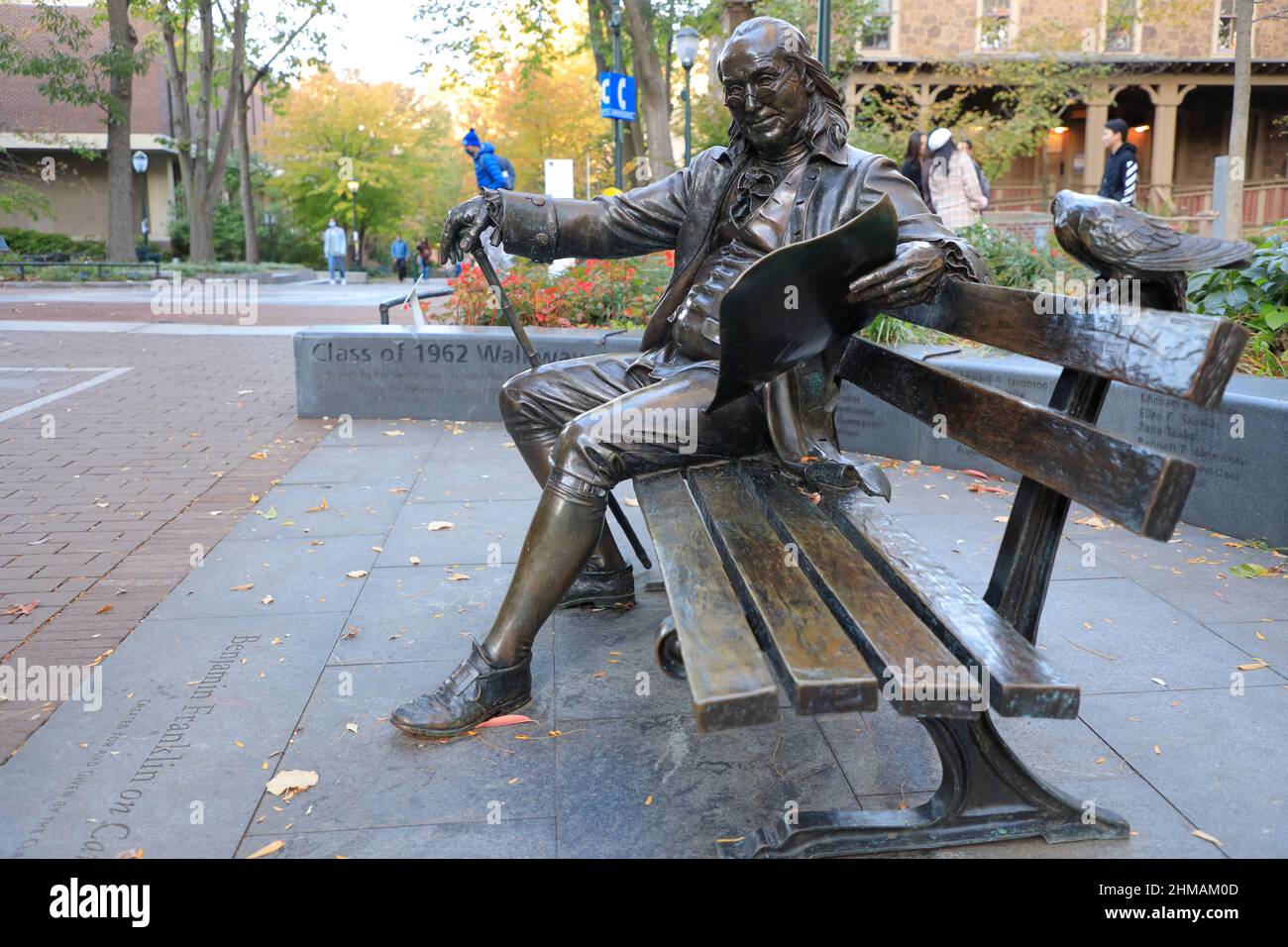 The bronze statue of Benjamin Franklin on a bench by George Lundeen as ...