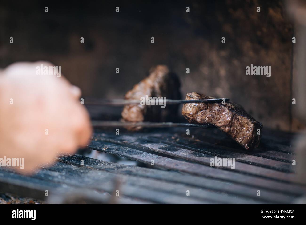 Selection of medium rare steaks, cut with knife with potato wedges as ...
