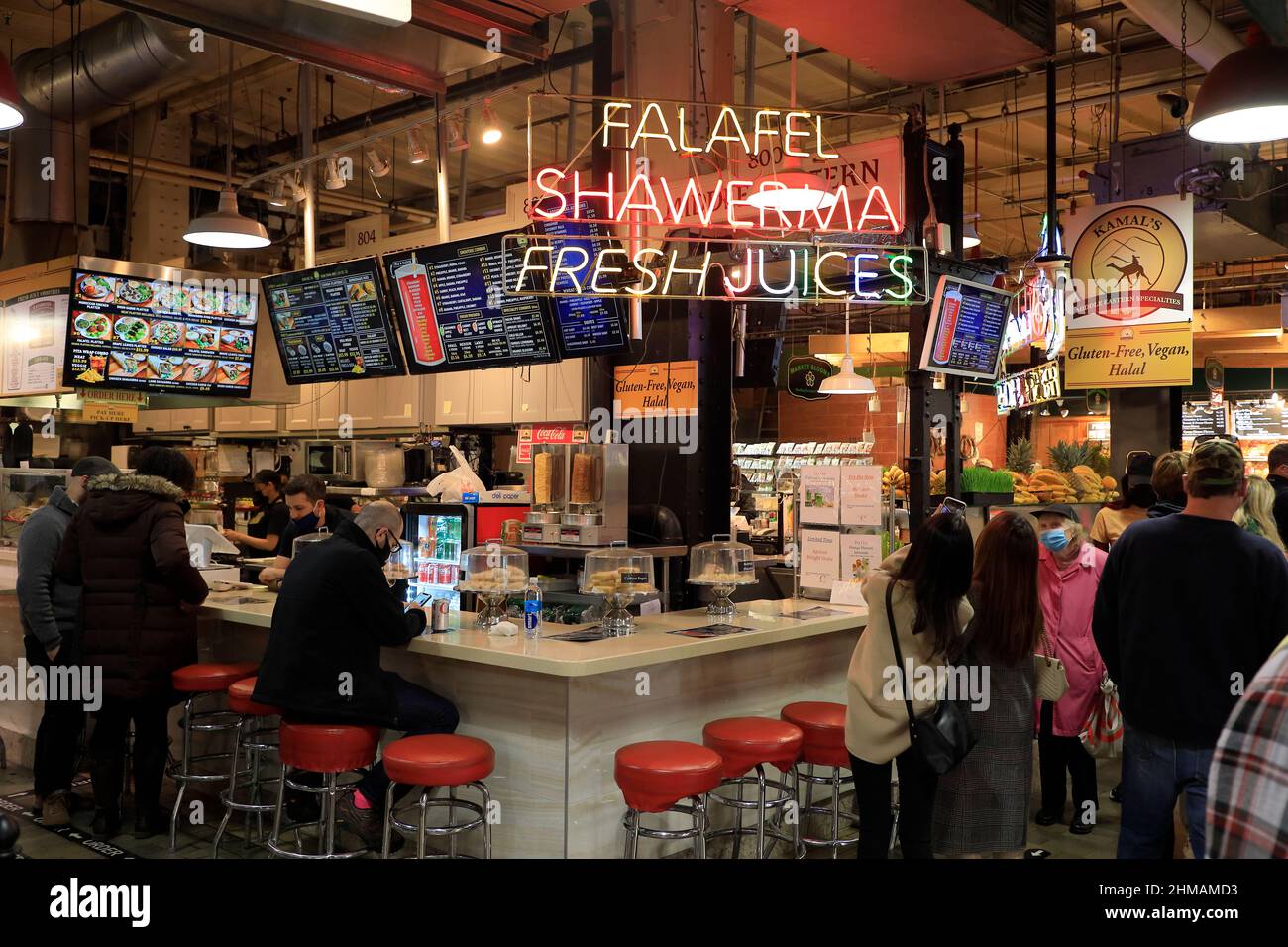 Lunch counter with neon signs of falafel shawerma and fresh juices in ...