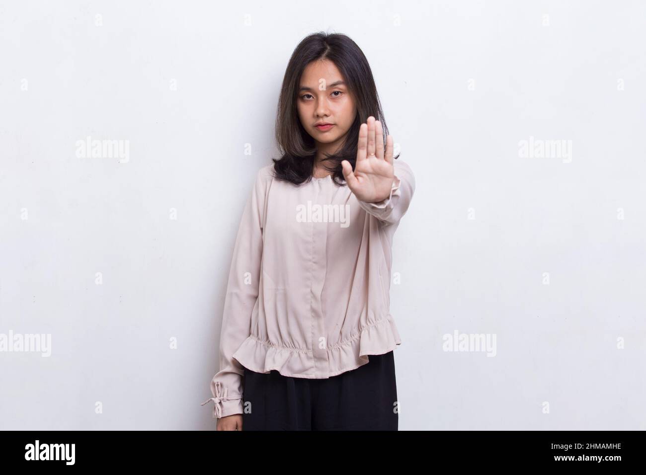 beautiful young woman with open hand doing stop sign with serious ...