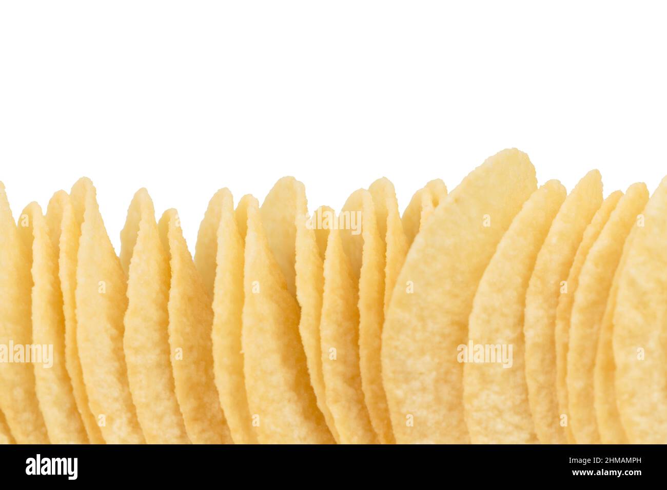 A pile of potato chips lined up in a row. Isolated over white ...