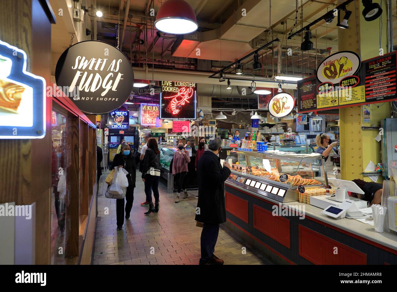 Interior view of Reading Terminal Market with customers and signs of ...