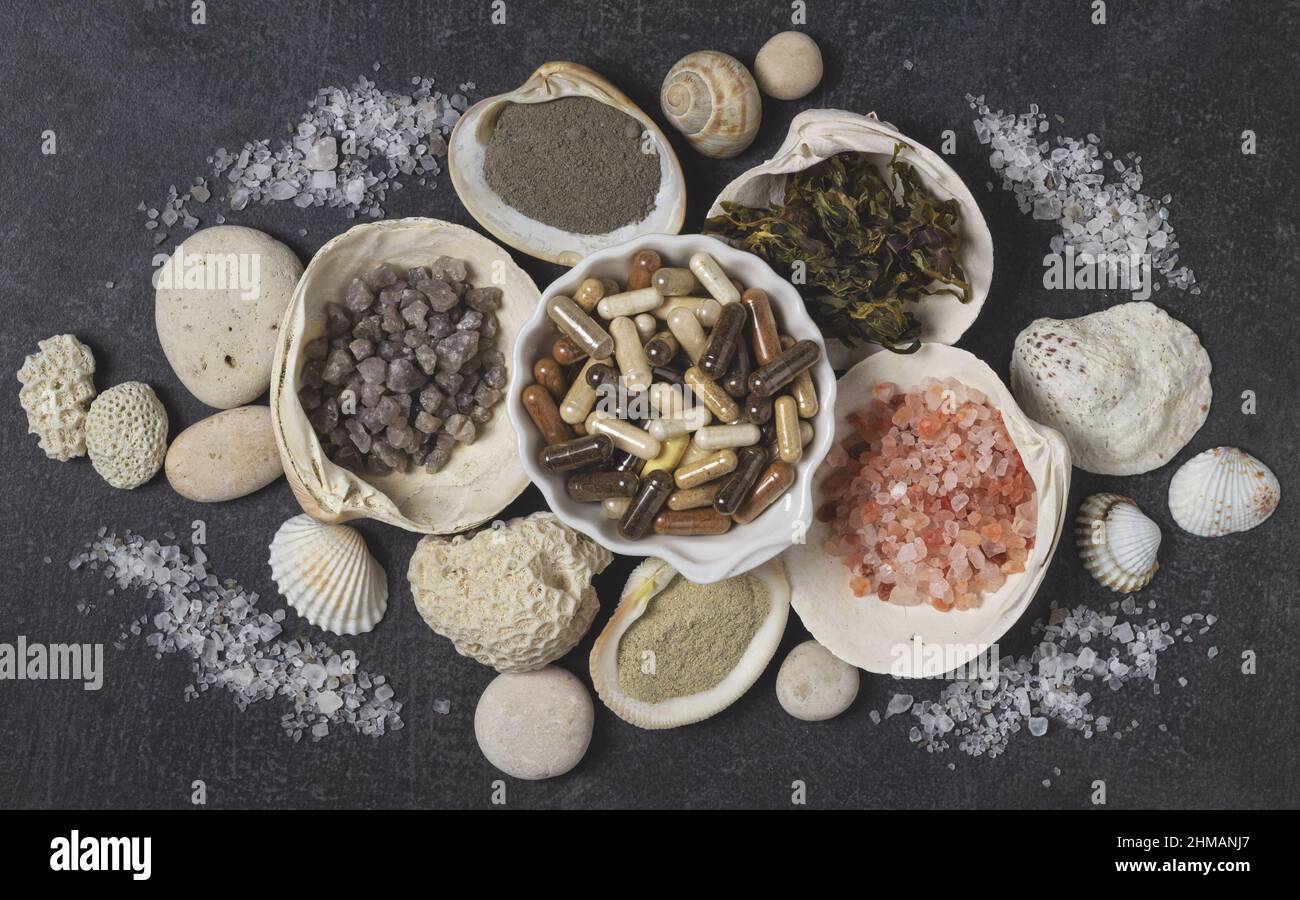 Dietary supplements in capsules, various crystals of salt, algae and ...